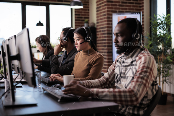 Sales assistant answering helpline call from client at helpdesk Stock ...