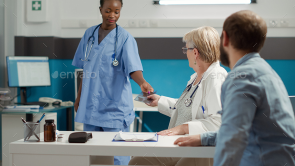 Senior physician showing x ray bones scan to sick patient Stock Photo ...