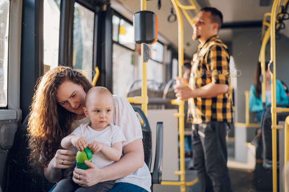 Mother and her child riding in a bus during a day. Stock Photo by ...