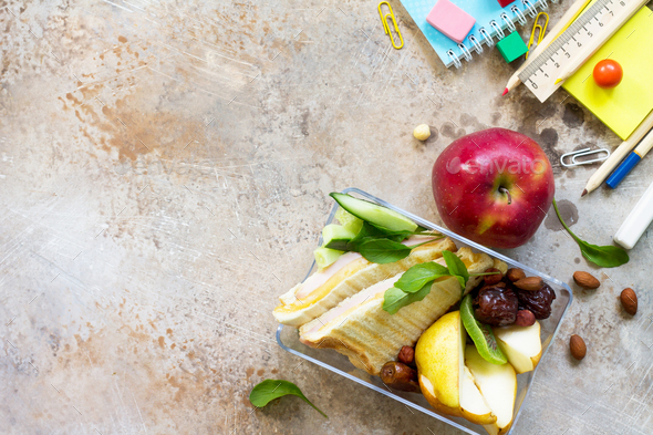 Back to school background with school supplies, lunch box and apple ...