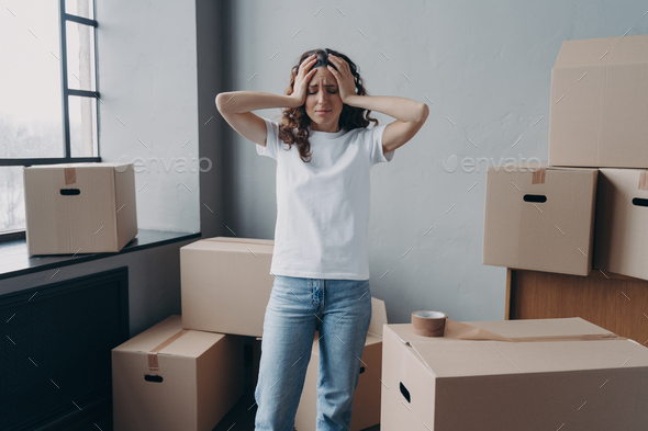 Exhausted woman is tired from packing cardboard boxes with duct tape ...