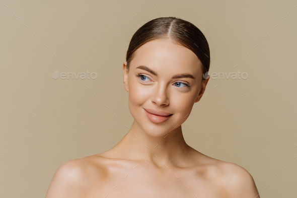 Portrait of good looking young woman has clean skin wears minimal ...