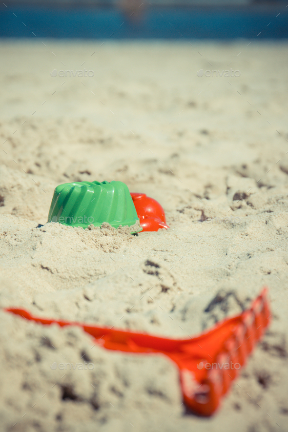 Plastic green rake and other toys using for relax or playing at beach ...