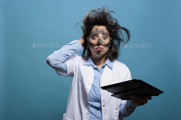 Insane looking biochemistry specialist with touchscreen device looking ...