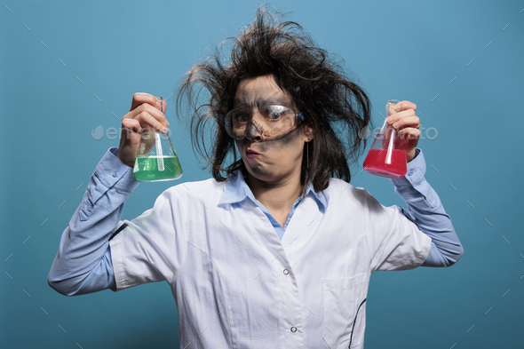 Mad chemist having beakers filled with toxic liquid substances while on ...