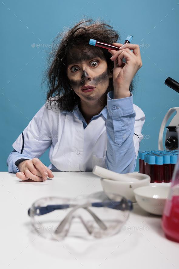 Potrait of crazy looking mad silly chemist with messy hair and dirty ...