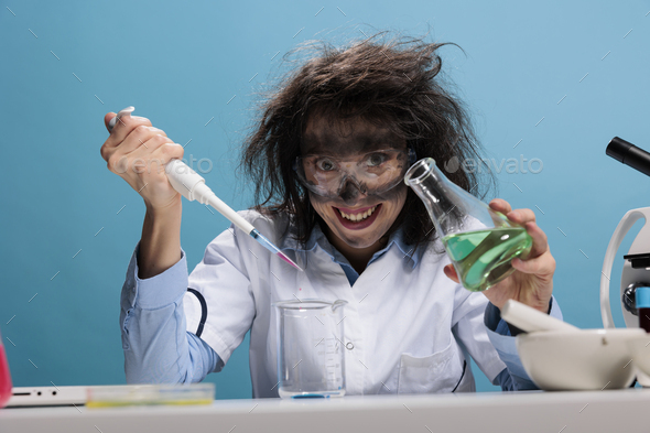 Grinning creepy lunatic silly looking mad scientist with dropper and ...