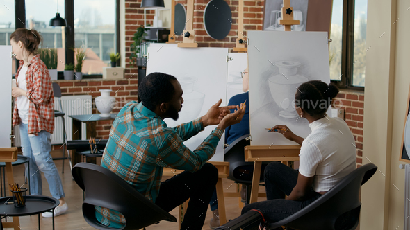 Man and woman attending art class lesson to develop drawing skills ...