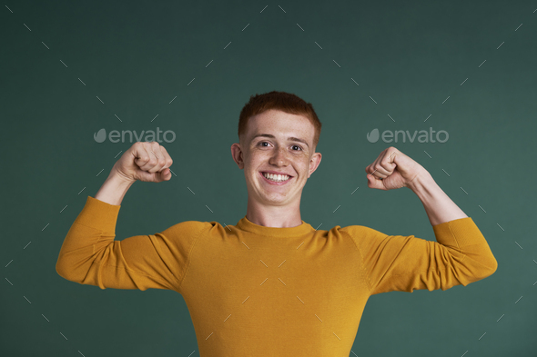 Caucasian red head teenage boy showing his strength Stock Photo by ...