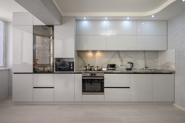 Interior of modern trendy white kitchen, front view Stock Photo by staRRush