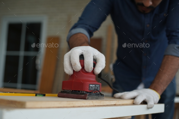 Carpenter or warehouse worker choosing raw wood material for the work ...