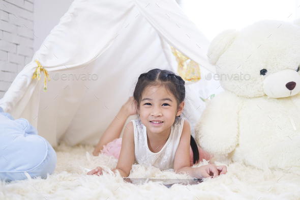 Happy children girl so cute smiling while at home. Stock Photo by ijeab