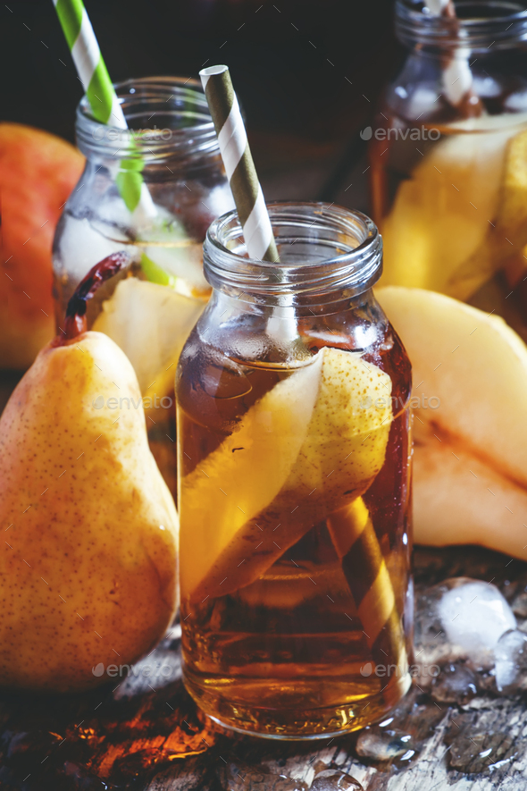 Cold pear juice with a straw, black background, selective focus Stock ...