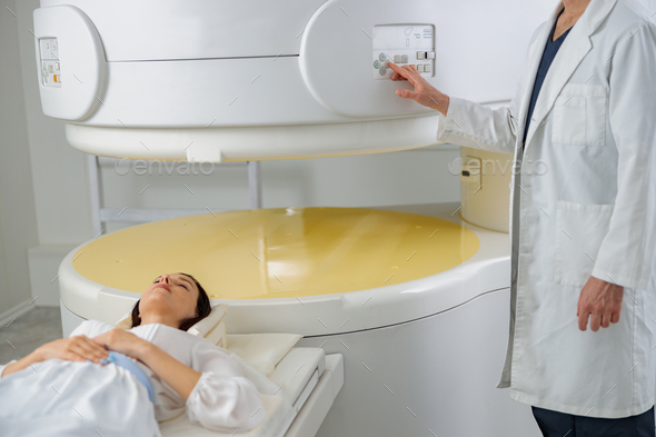 Woman patient is ready to do magnetic resonance imaging MRI or CT scan ...