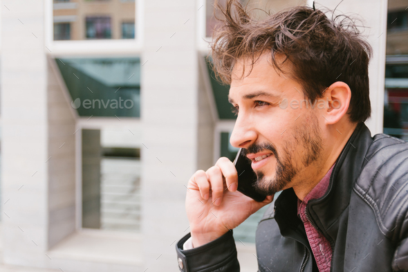 Handsome man telephoning on the street of his city. smartphone and ...