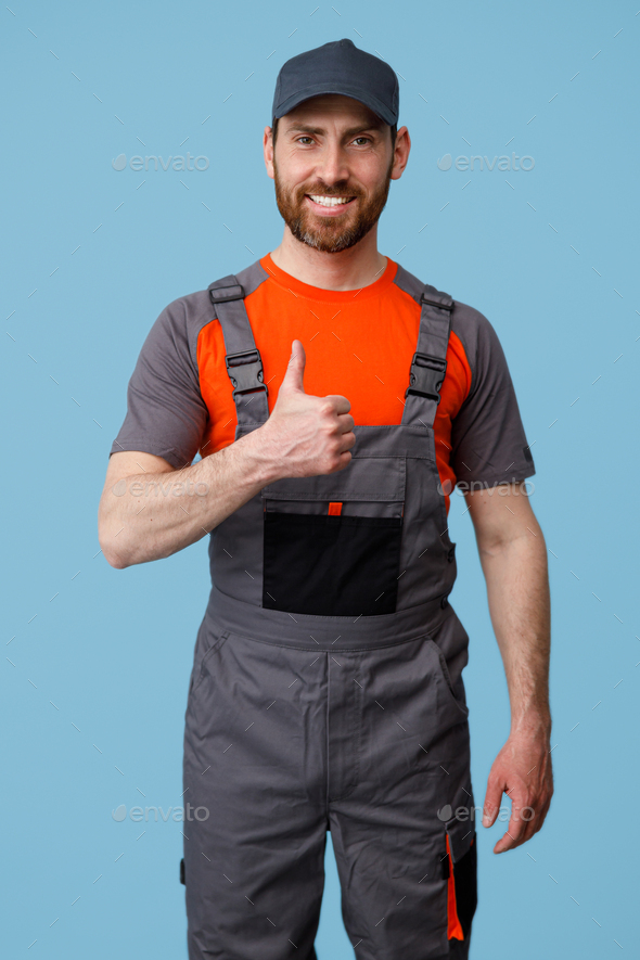 Portrait of smiling workerman In uniform showing thumbs up Stock Photo ...