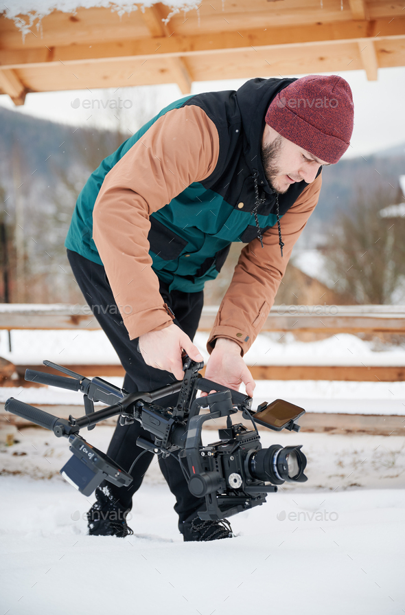 videographer man with camera mounted on gimbal stabilizer equipment in ...