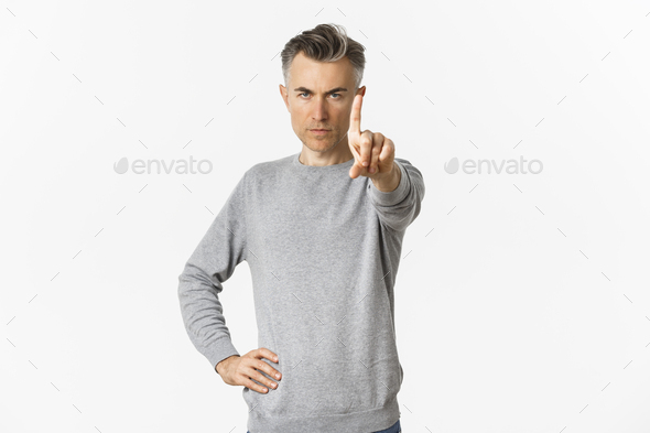 Image of serious-looking and confident middle-aged man telling no ...