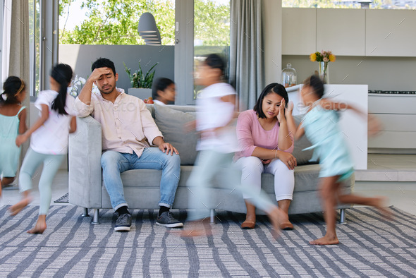 We need a getaway. Shot of two parents looking exhausted while their ...