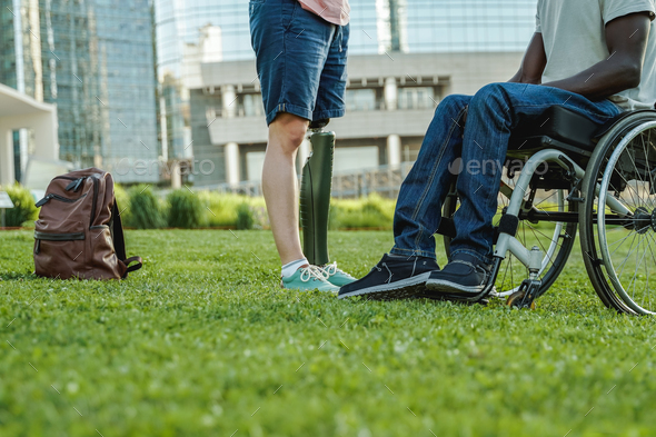 Diverse friends with physical disability having fun outdoor - Focus on ...