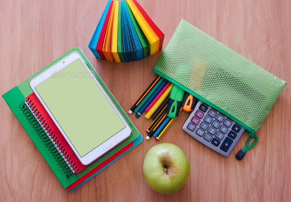 Group of school supplies and books and digital tablet with wide screen ...