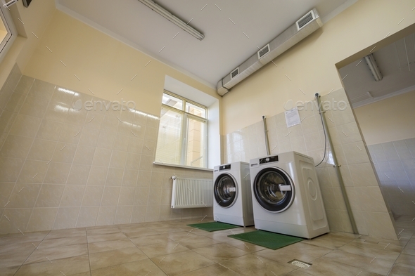 Modern new industrial washing machines on rubber insulation mats Stock ...