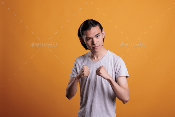 Serious man standing in fighting pose, strength concept Stock Photo by ...