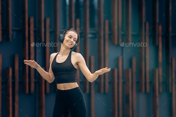 Pretty young female standing, dancing. Stock Photo by tymoshchukph