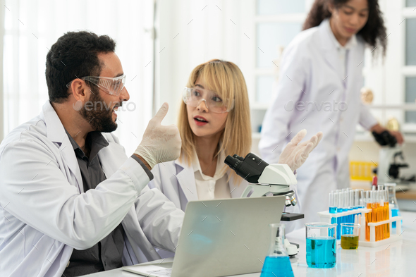 People working in the laboratory, Using Magnifying Glass on Microscope ...