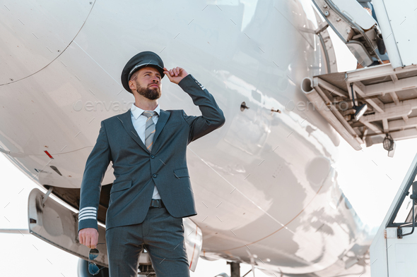 Male aircraft pilot standing outdoors at airport Stock Photo by friends ...