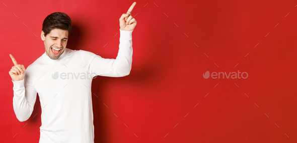 Portrait of handsome man enjoying new year party, dancing and having ...