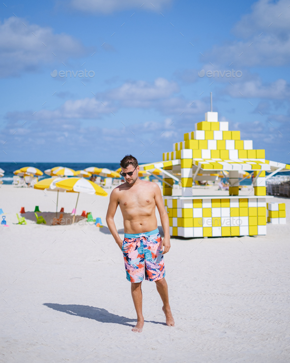 Miami beach, young men on the beach at Miami beach, lifeguard hut Miami ...