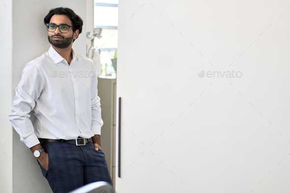 Elegant rich successful young indian business man standing in office ...