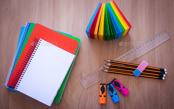 Group of school supplies and books over a desk, student accessories ...