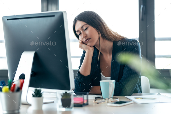 Elegant business woman sleeping while working with computer in the ...