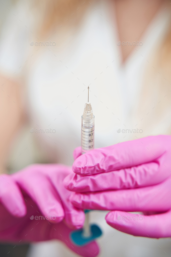 Image of cosmetologist arms in pink gloves with injection Stock Photo ...