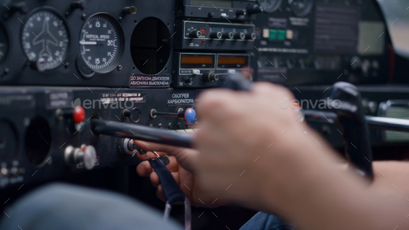 Pilot starting airplane engine using key sitting in modern plane cabin ...