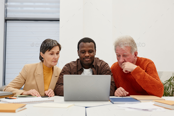 Teacher teaching his students to use laptop Stock Photo by ...