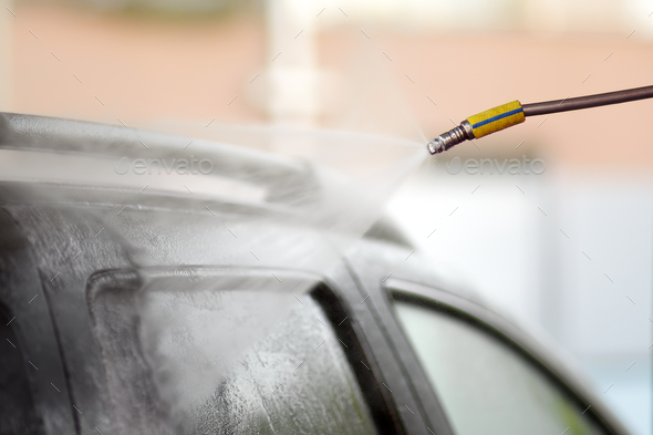 Car washing. Cleaning automobile using high pressure jet water. Stock ...