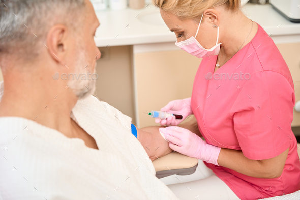 Nurse finished drawing the patient blood into the syringe Stock Photo ...