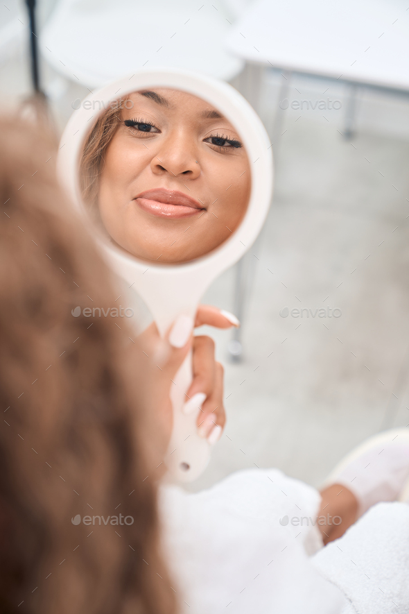 Reflection of a beautiful female face in the mirror Stock Photo by ...