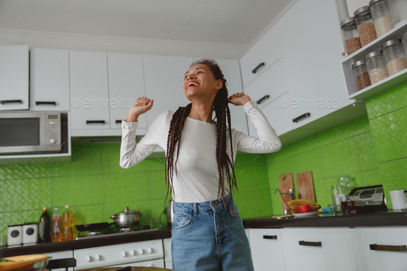 Bottom view of happy young female having fun at home dancing in the ...