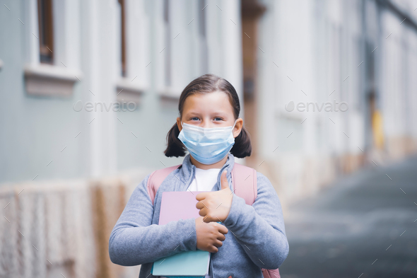 School girl with face mask in front of her school Stock Photo by erika8213