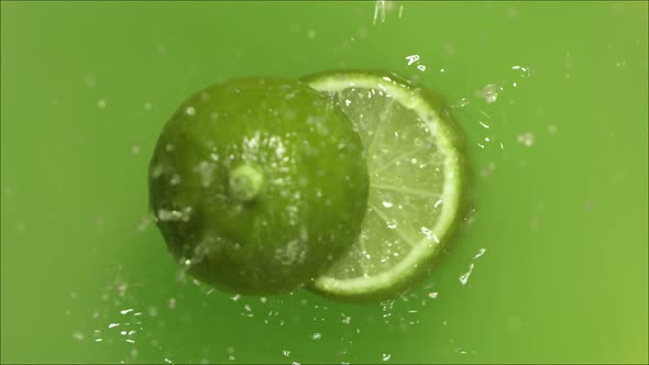 Lime Falling on Juice and Divided in Half, Stock Footage | VideoHive