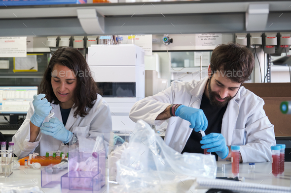Two young phD students working in a real laboratory. Stock Photo by ...