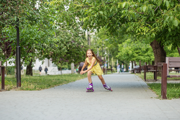 Child rollerblading fast at skate park. Having fun. Concept of an ...