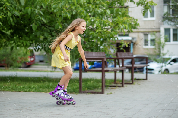 Child rollerblading fast at skate park. Having fun. Concept of an ...