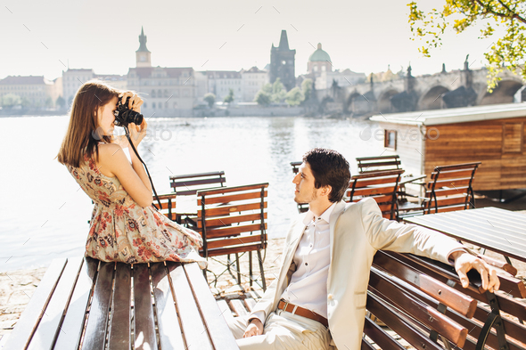 Professional beautiful female photographer makes photo of her husband ...