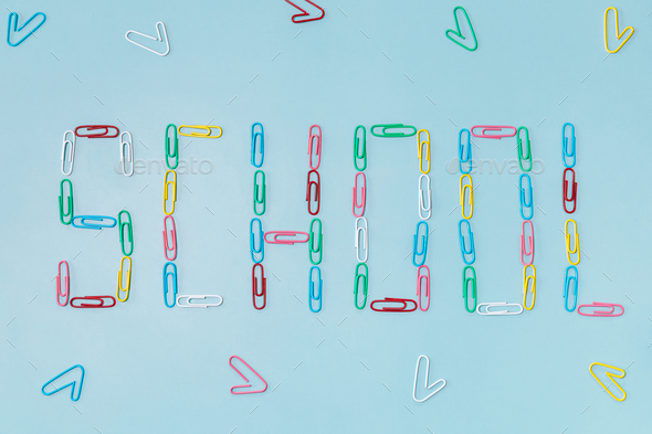 Paperclip on blue background, lettering that Back to school concept ...