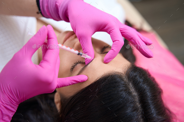 Injections into the skin of the forehead against skin aging Stock Photo ...